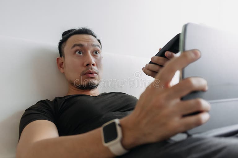 Distracted Creative Designer Man Lying on Sofa Working Watching Tv ...