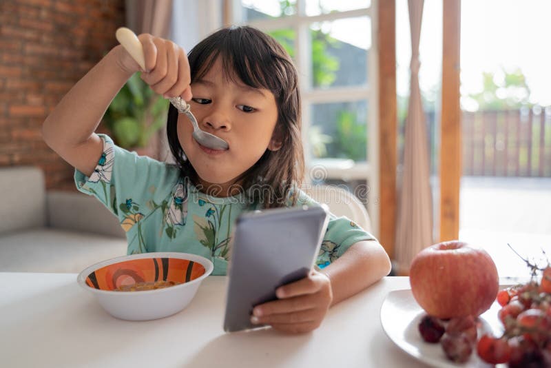 Distracted Kid Using Mobile Phone while Having Breakfast Stock Photo ...