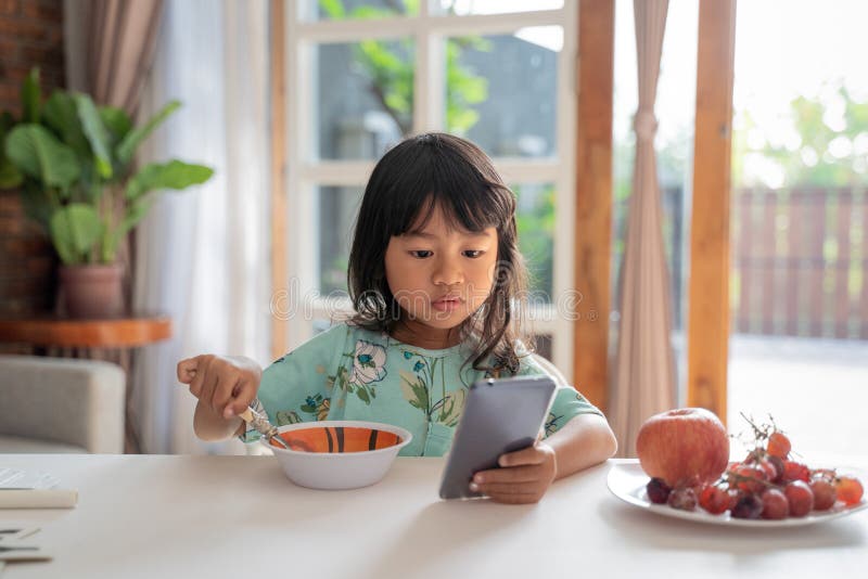Distracted Kid Using Mobile Phone while Having Breakfast Stock Photo ...