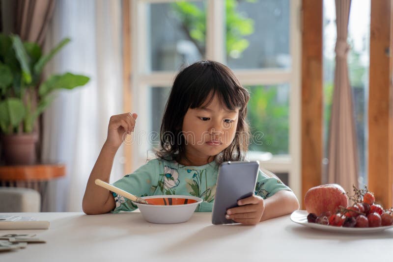 Distracted Kid Using Mobile Phone while Having Breakfast Stock Photo ...