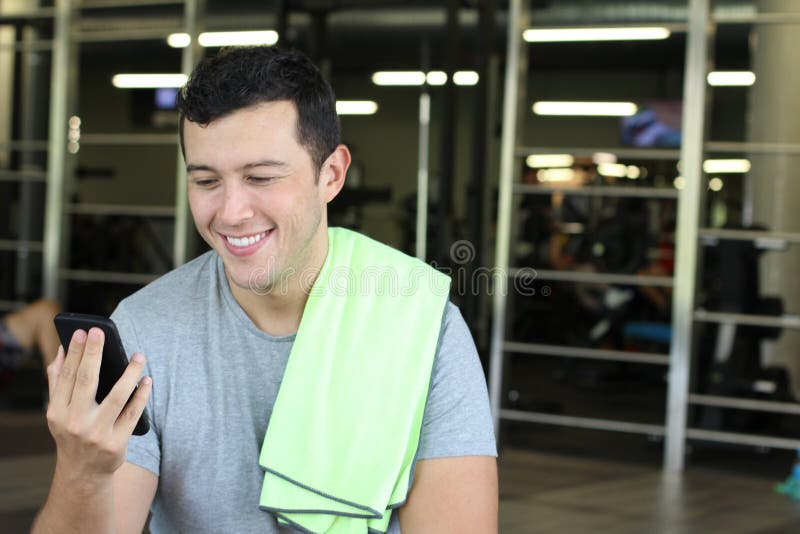Distracted Man with Cellphone at the Gym Stock Photo - Image of ...