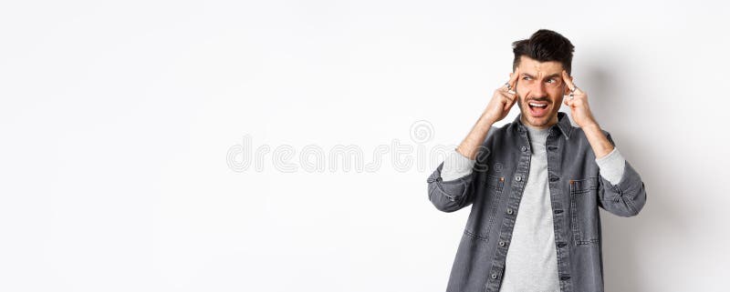 Distressed Young Man Touching Head and Shouting, Looking Frustrated ...