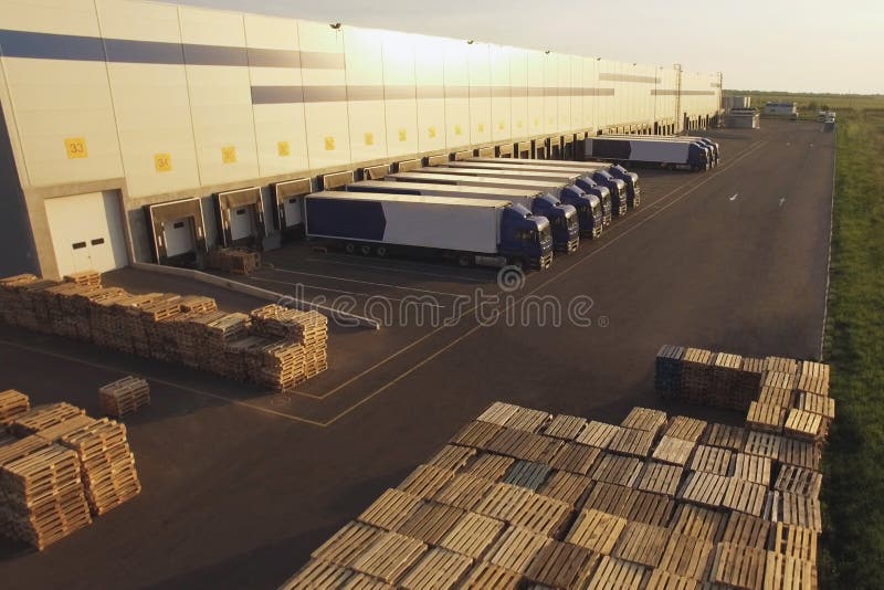 Large Warehouse Complex with Parked Trucks Awaiting Loading. Logistics ...