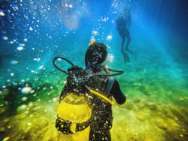 Diver Back To Camera, Looking To Another Diver in the Sea. Stock Image ...