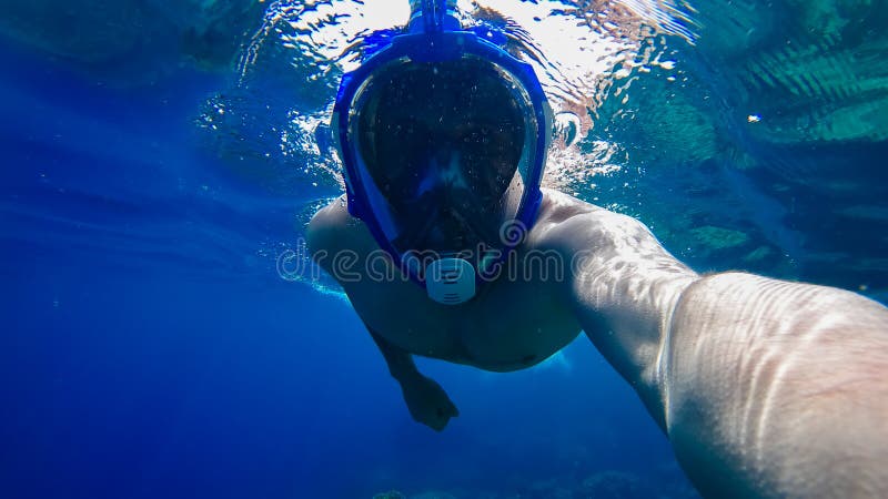 Diver in an Underwater Mask Swims at the Bottom of the Blue Sea Stock ...