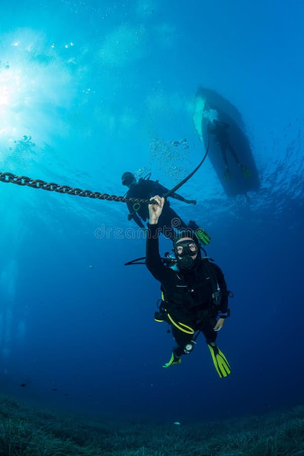 Divers Making a Decompression Stop Under Their Diving Boat Stock Image ...