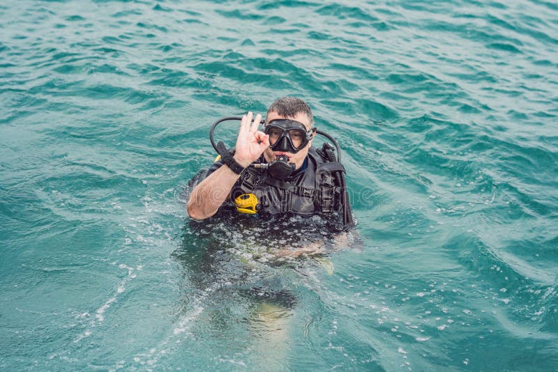 Divers on the Surface of Water Ready To Dive Stock Image - Image of ...
