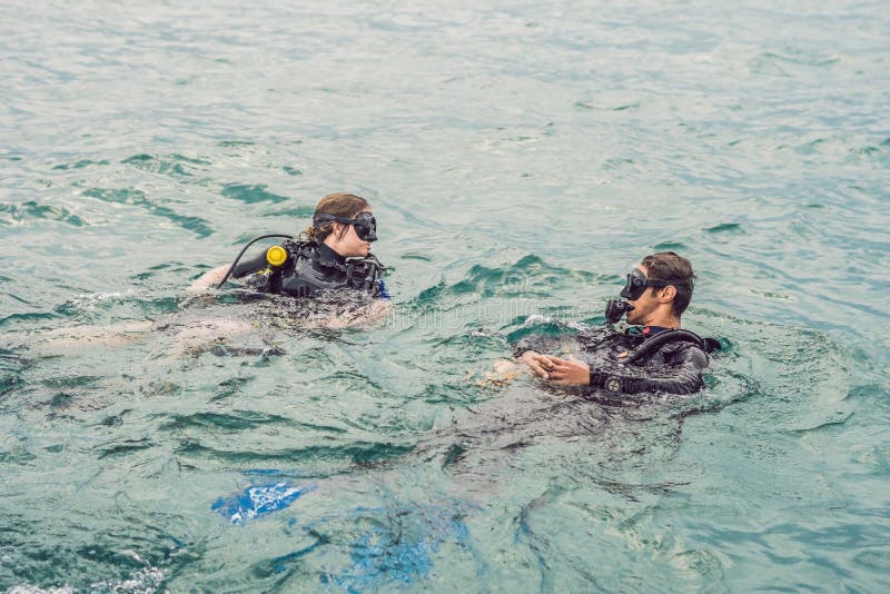 Divers on the Surface of Water Ready To Dive Stock Image - Image of ...