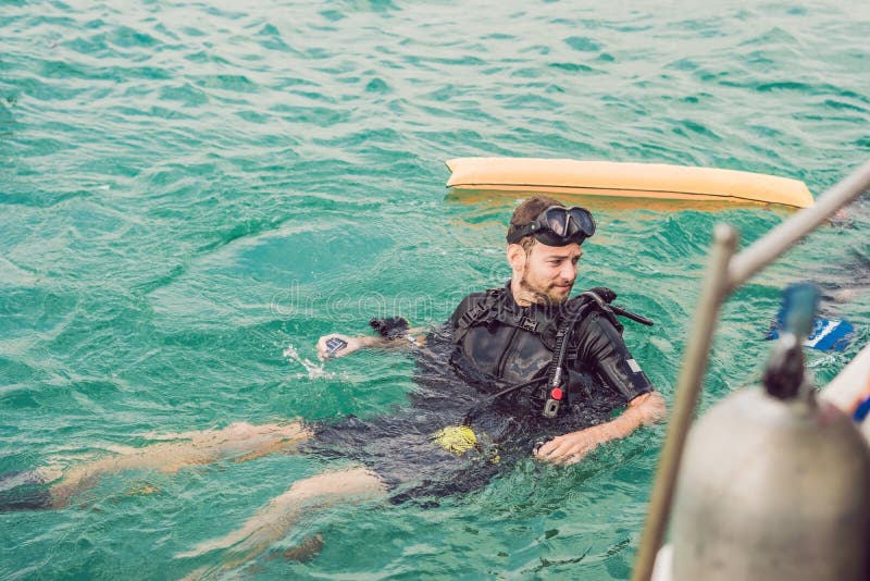 Divers on the Surface of Water Ready To Dive Stock Image - Image of ...