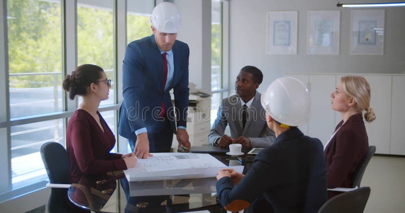 Diverse Architects Discussing Blueprint with Construction Manager in ...