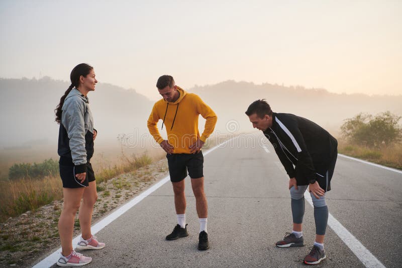 Diverse Athletic Warm-Up: Group Prepares for Intense Running Challenge ...