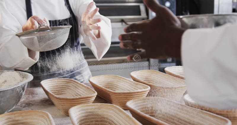 Diverse Bakers Working in Bakery Kitchen, Pouring Flour on Baskets in ...