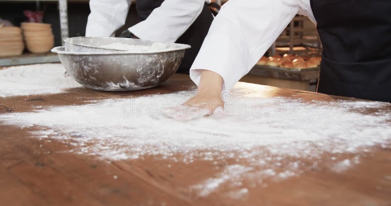 Diverse Bakers Working in Bakery Kitchen, Spreading Flour on Counter in ...