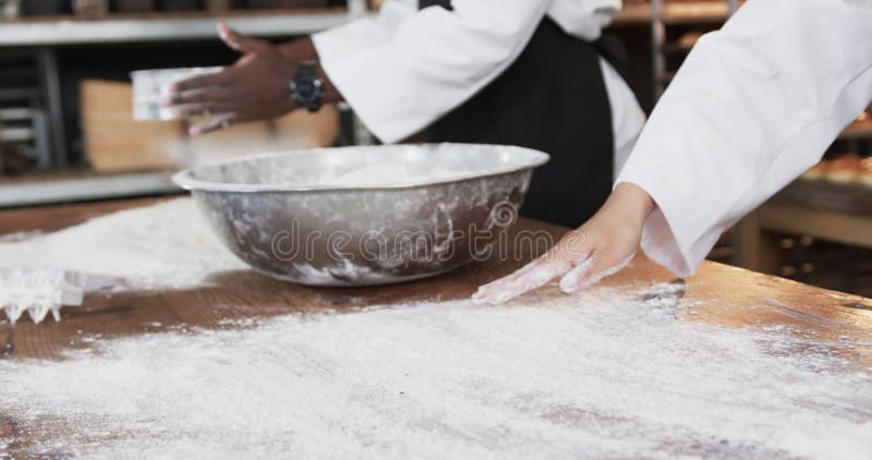 Diverse Bakers Working in Bakery Kitchen, Spreading Flour on Counter in ...