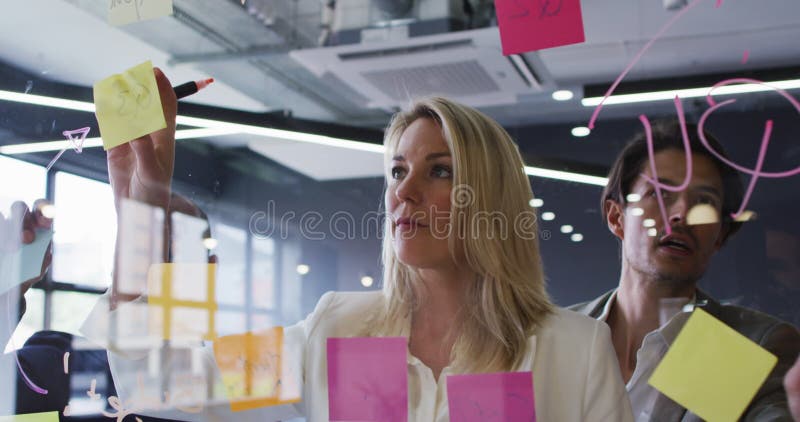 Diverse Business People Standing Using a Board Brainstorming in Modern ...