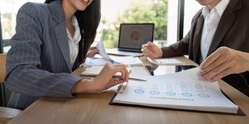 Diverse Business Team Analyzing Project Management Plans and Discussing ...