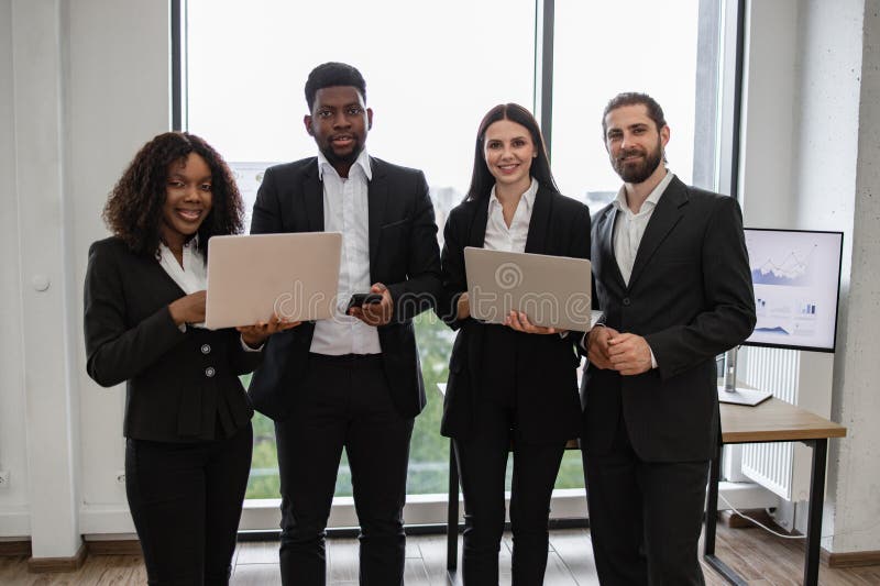 Diverse Business Team with Laptops in Modern Office Stock Photo - Image ...