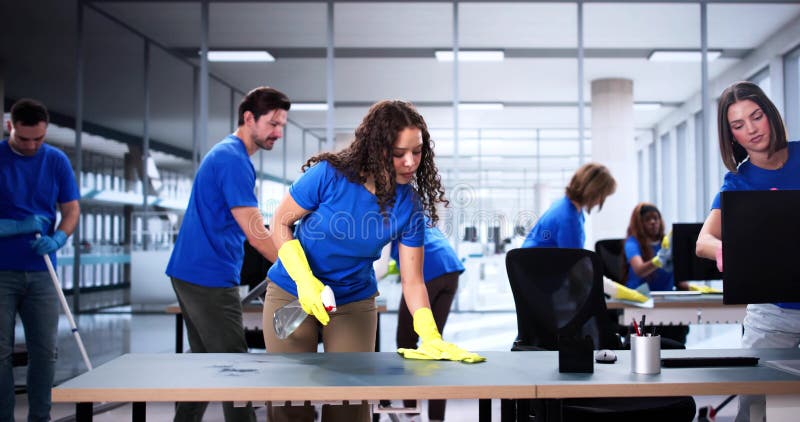 Diverse Cleaning Team Professionally Services Office with Caution Stock ...