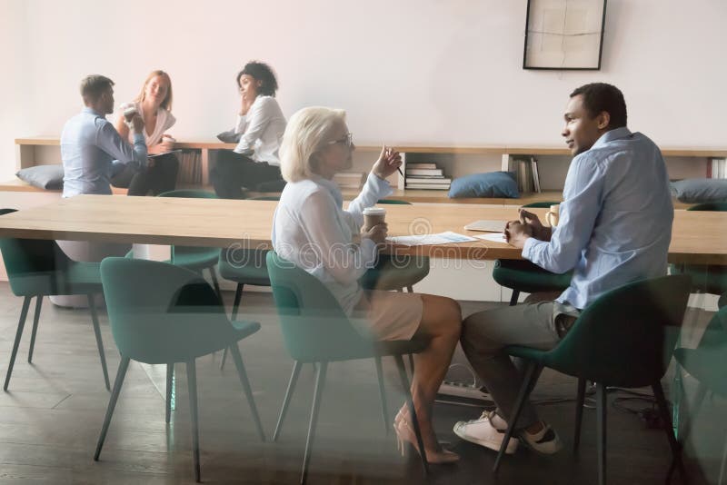 Diverse Colleagues Designers or Manager and Client Talking at Meeting ... Diverse Colleagues Designers or Manager and Client Talking at Meeting ...