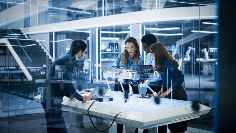 Diverse Colleagues Work in Industrial Robotics Factory, Experimenting ...