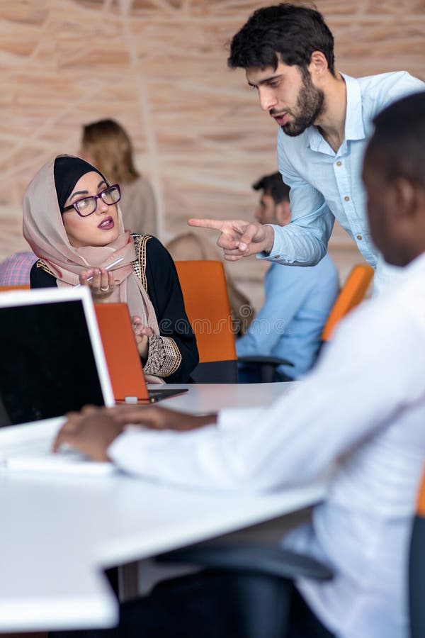 Diverse College Students Using Laptop and Talking, Learning Exchanging ...