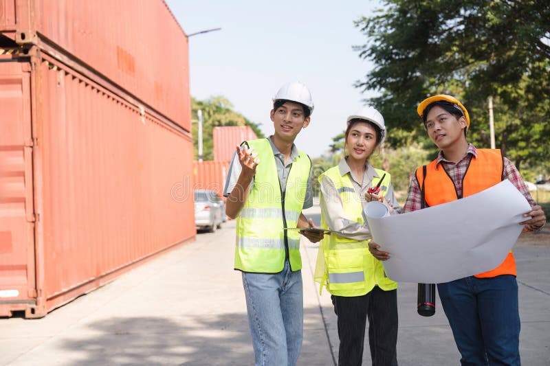Construction Team Discussing Project Blueprints and Plans at a Bustling ...