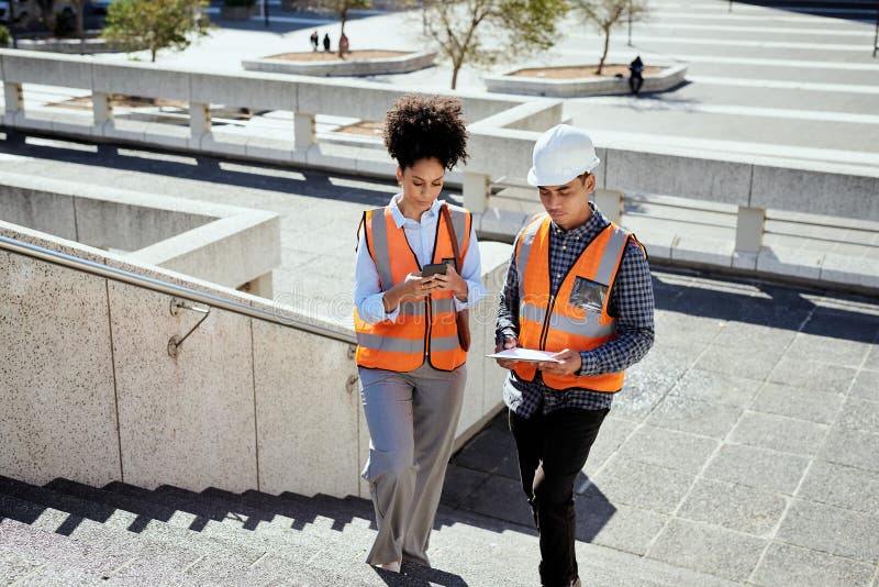 Diverse Construction Workers Collaborating with Digital Devices on ...