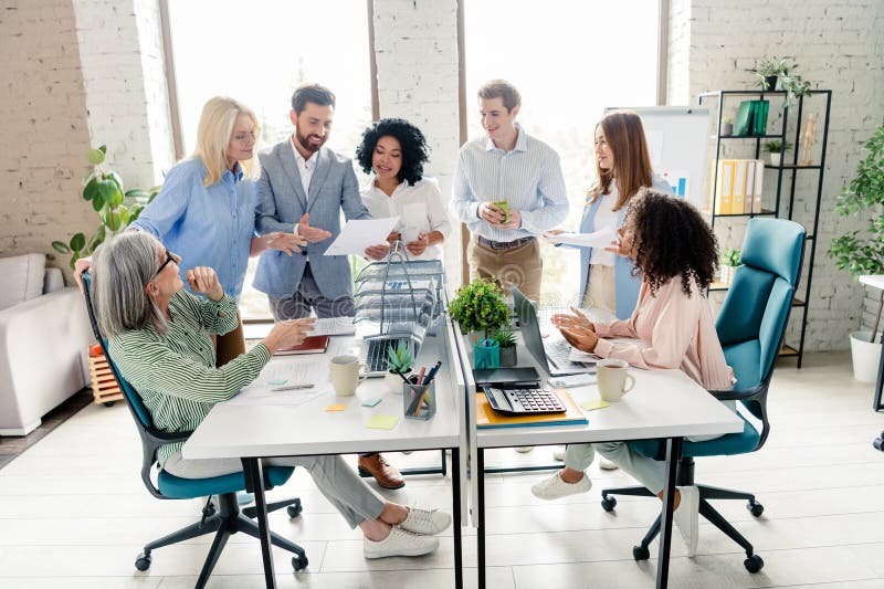 Diverse Coworkers Discussing Project in Modern Light-filled Office ...
