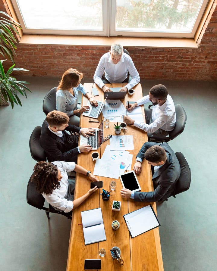 Diverse Coworkers Working Using Computers Sitting at Desk in Office ...