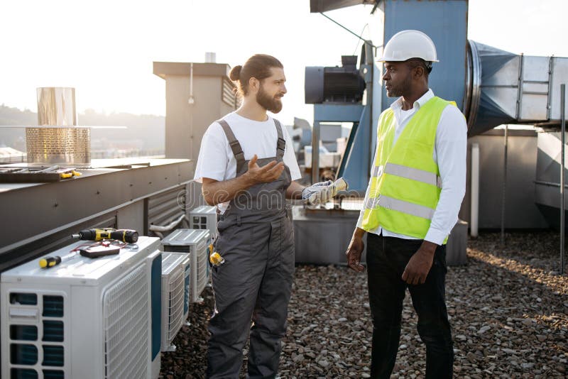 Diverse Craftsmen Standing and Discussing Issues Outdoor Stock Photo ...