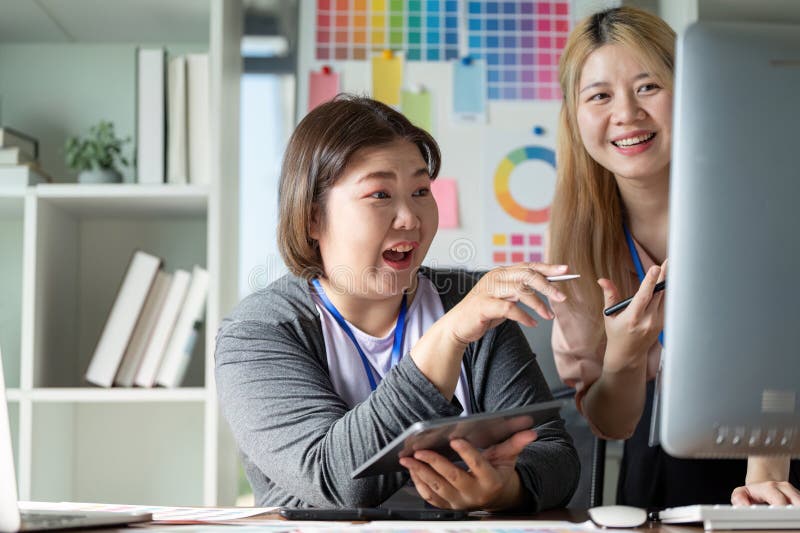 Diverse Design Team Collaborating on a Graphics Project in a Creative ...