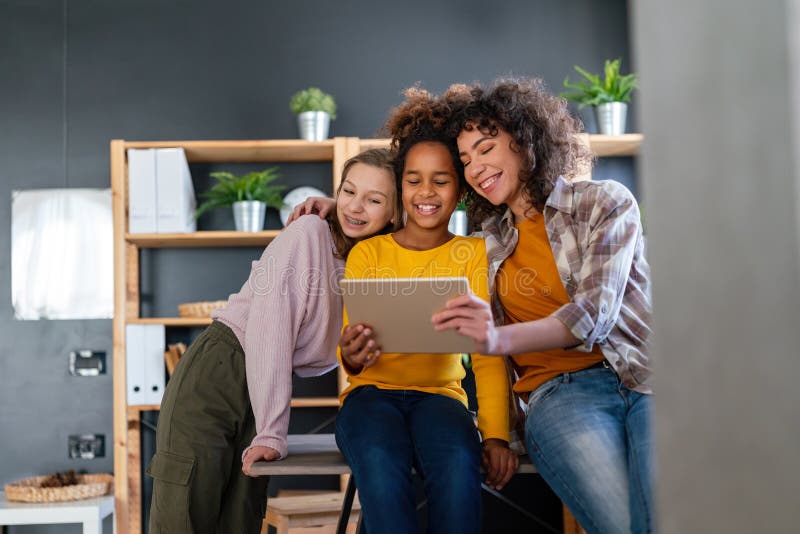 Diverse Ethnicity Student Girls, Sisters Using a Digital Gadgets ...