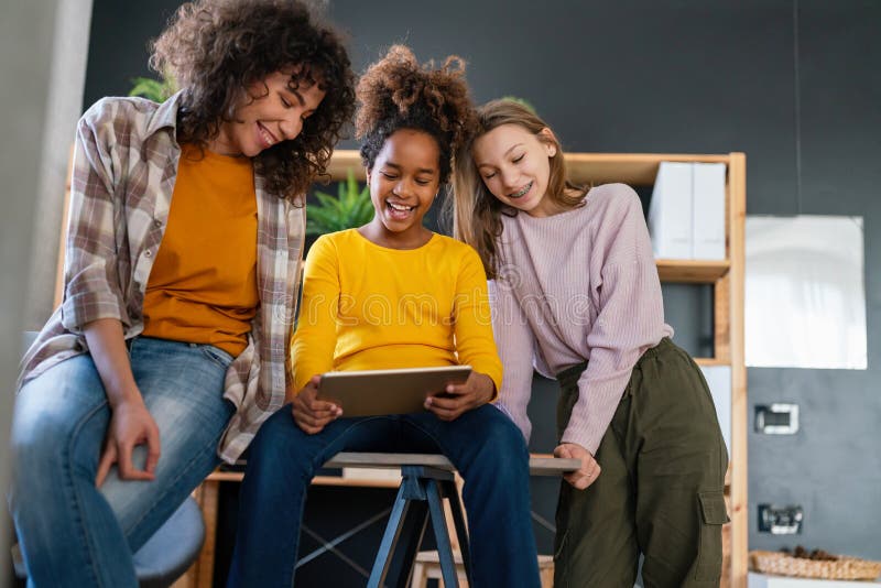 Diverse Ethnicity Student Girls, Sisters Using a Digital Gadgets ...