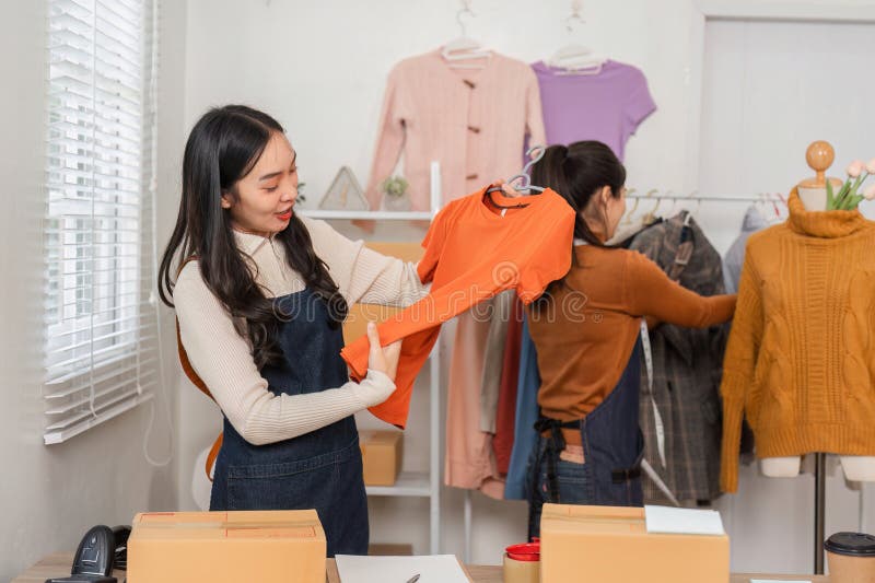 Diverse Female E-commerce Employees Organizing Clothing Items in Retail ...