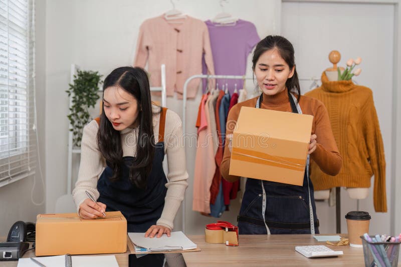 Diverse Female E-commerce Employees Preparing Packages for Shipment in ...
