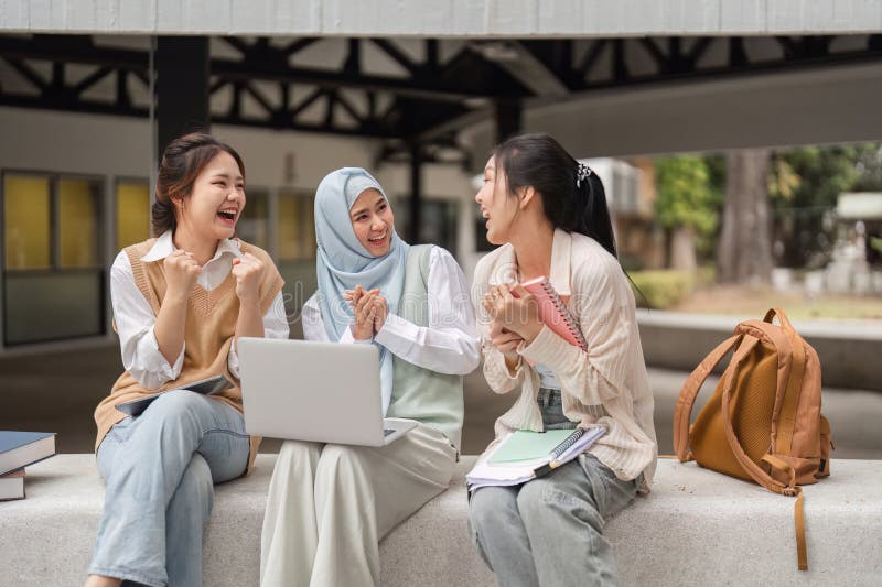Diverse Female Students Joyfully Collaborating and Sharing Ideas on ...