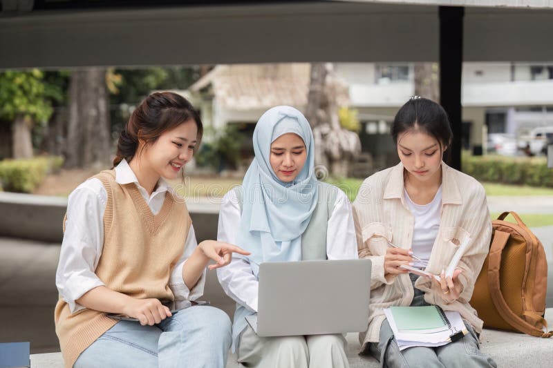 Diverse Female Students Studying Together with a Laptop and Notebooks ...