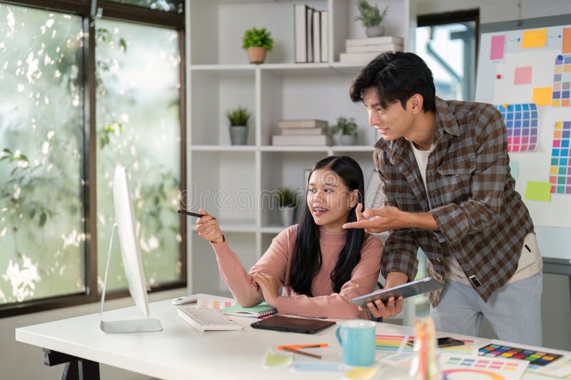 Diverse Graphic Design Team Collaborating and Presenting Ideas Using a ...