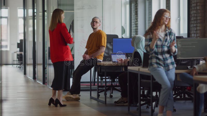 A Diverse Group of Business Colleagues Engage in Discussions about ...