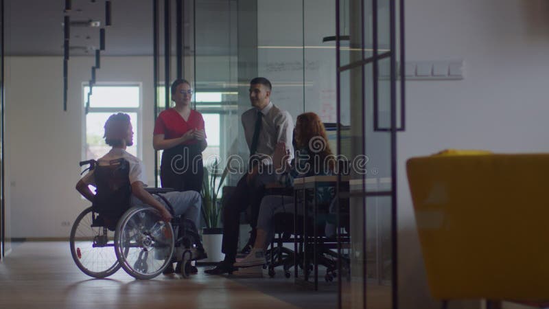 A Diverse Group of Business Colleagues Engage in Discussions about ...