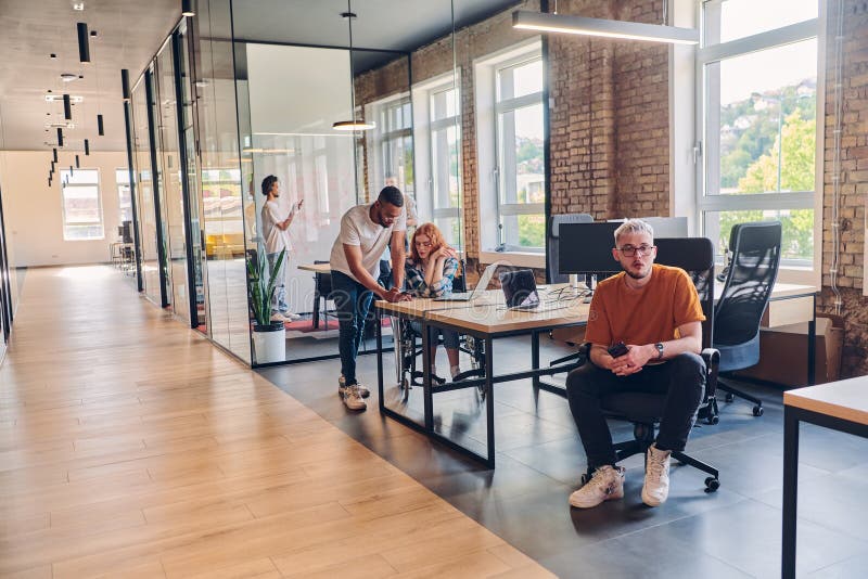 A Diverse Group of Business Professionals Collaborates in a Modern ... A Diverse Group of Business Professionals Collaborates in a Modern ...