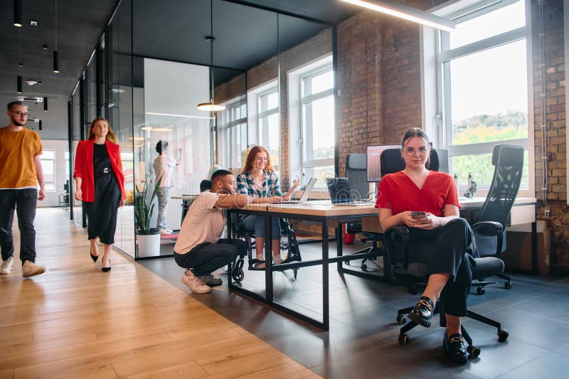 A Diverse Group of Young Business People Congregates within a Modern ...