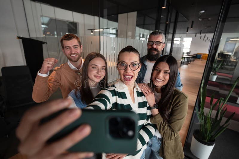A Diverse Group of Business Professionals Take a Break from Their Tasks in a Modern Startup Open ...