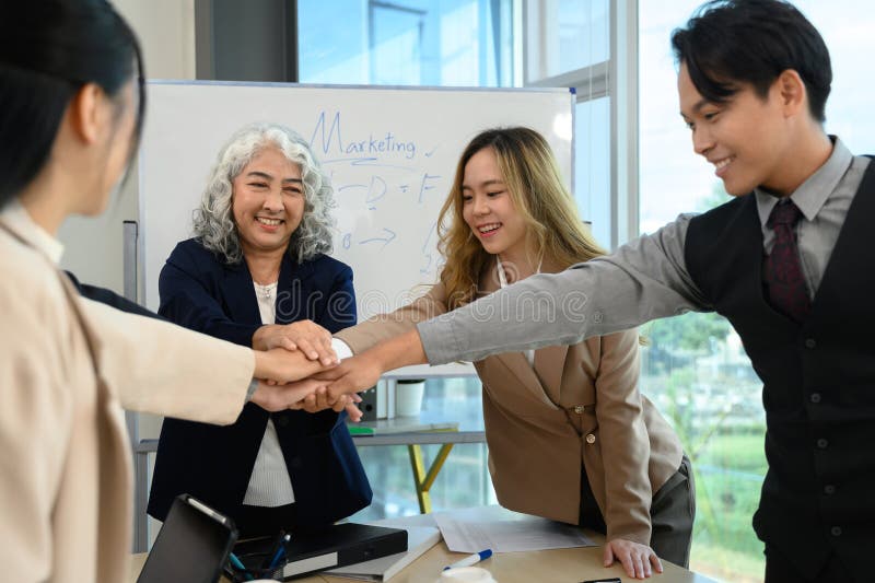 Diverse Group of Businesspeople Stacking Hands Together in Show of ...