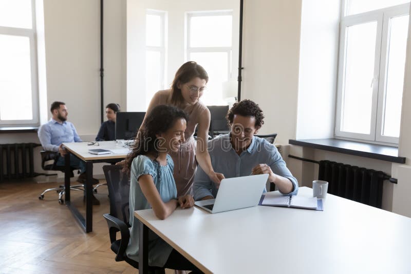 Diverse Group of Cheerful Employees Sharing Computer at Office Table ...