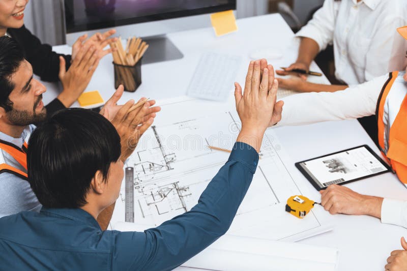 Diverse Group of Civil Engineer and Client Celebrate and High Five ...