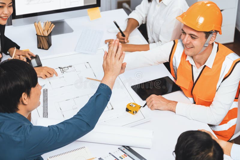 Diverse Group of Civil Engineer and Client Celebrate and High Five ...