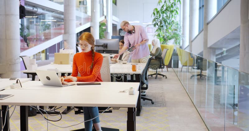 A Diverse Group of Colleagues Collaborates in Modern Offices ...