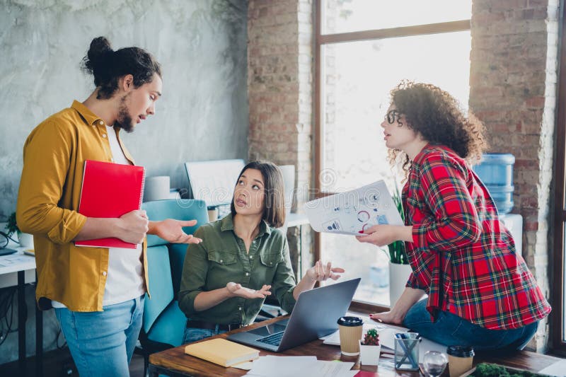 Diverse Group of Colleagues Discussing Project Details in a Casual ...
