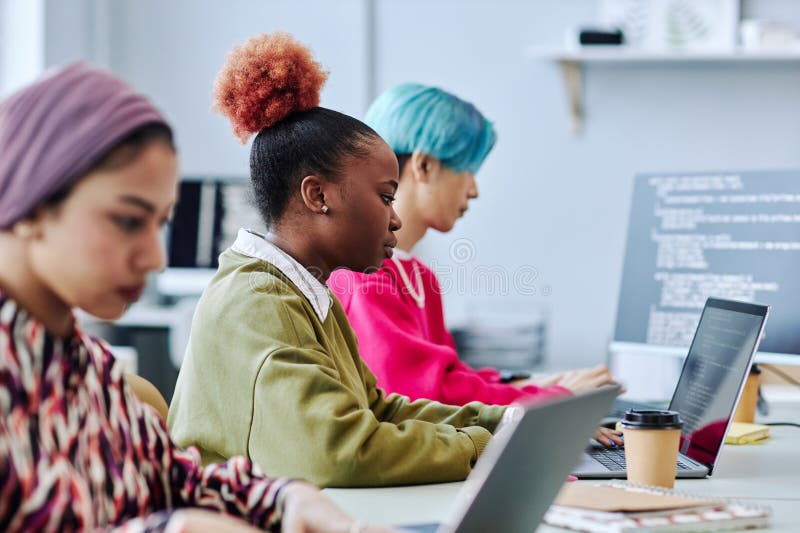 Diverse Group of Creative Young People Sitting in Row Working in Office ...